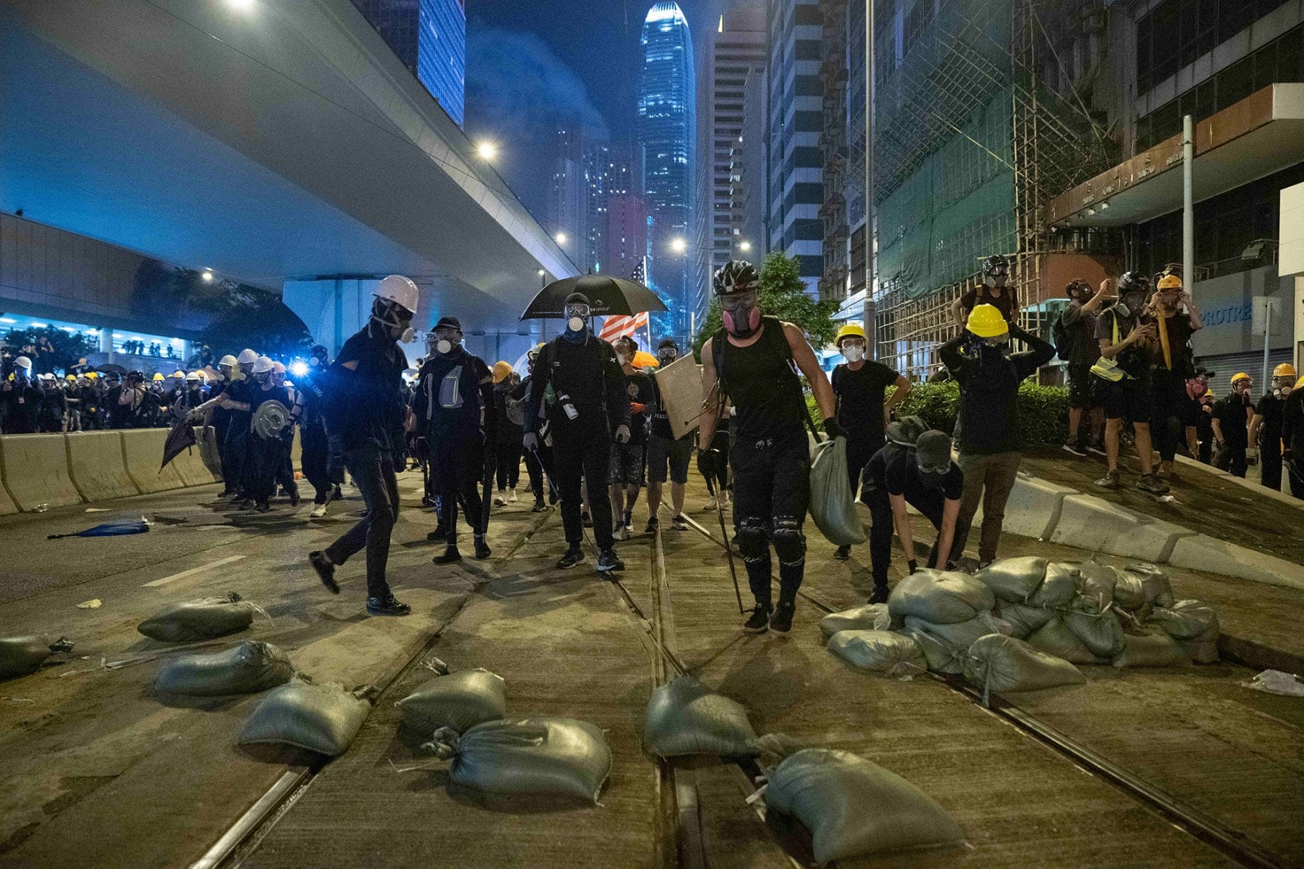 Hong Kong police hit back after angry crowds surround police stations ...